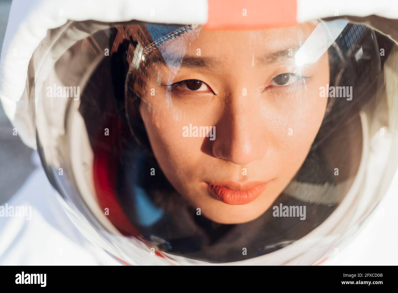 Female astronaut looking up wearing space helmet Stock Photo - Alamy