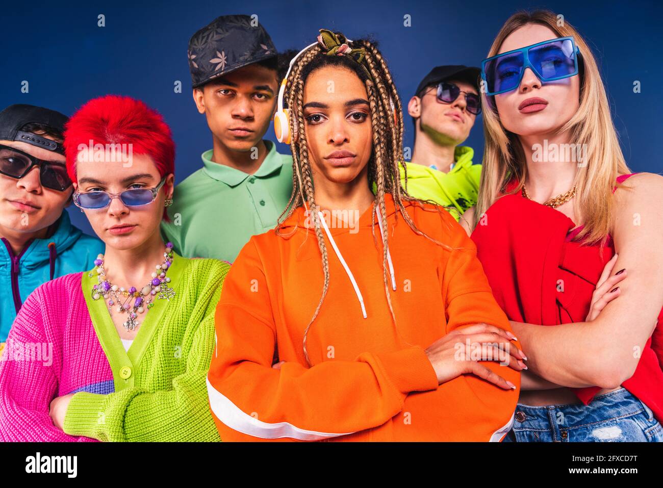 Young friends with arms crossed standing together Stock Photo - Alamy