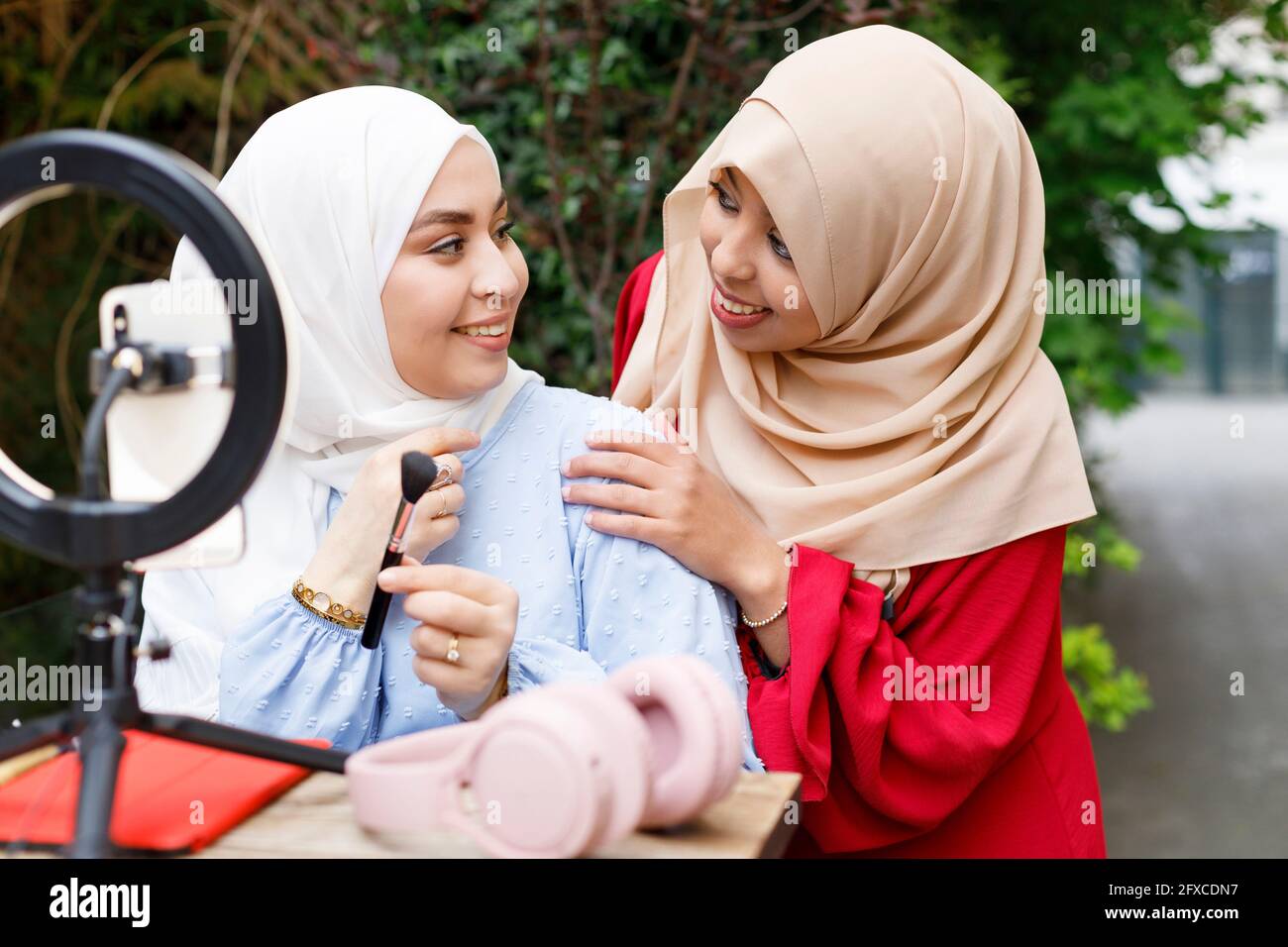 Female influencer with friend vlogging Stock Photo - Alamy