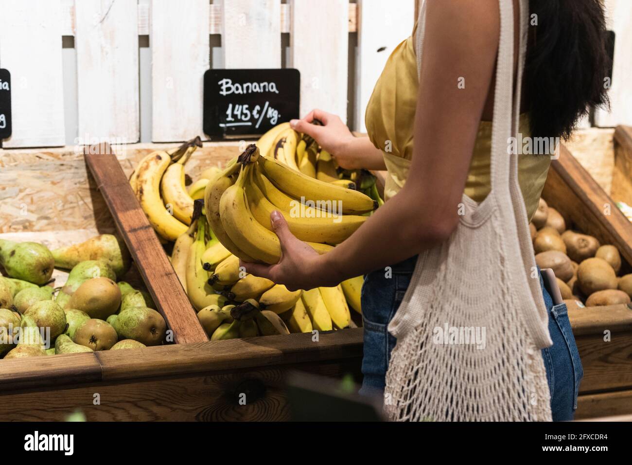 Woman choosing bananas at grocery store Stock Photo - Alamy
