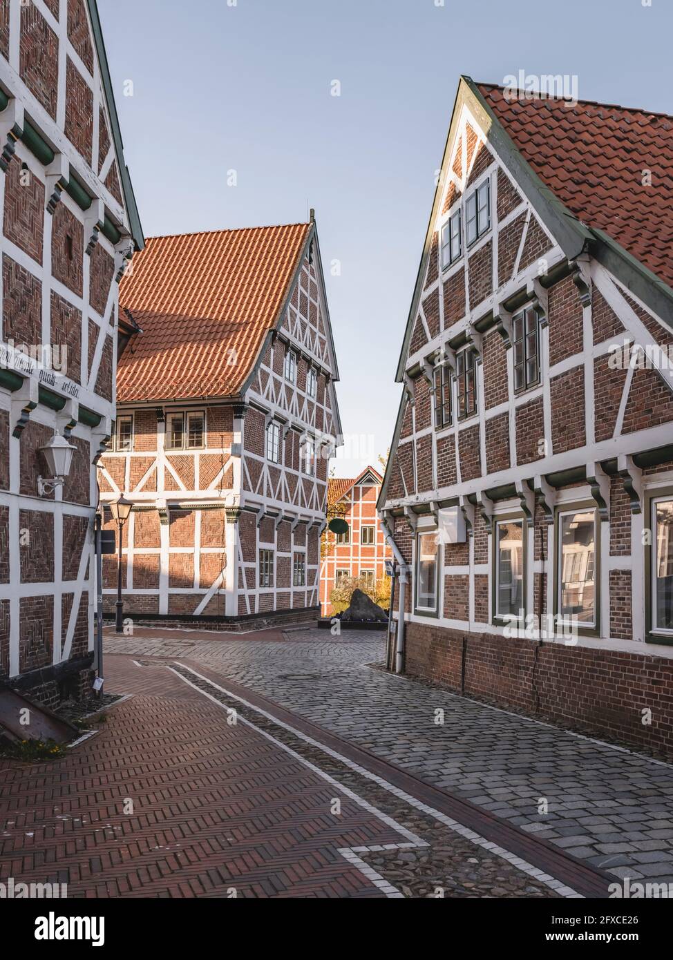 Germany, Altes Land, Jork, Quaint street with half timbered buildings ...