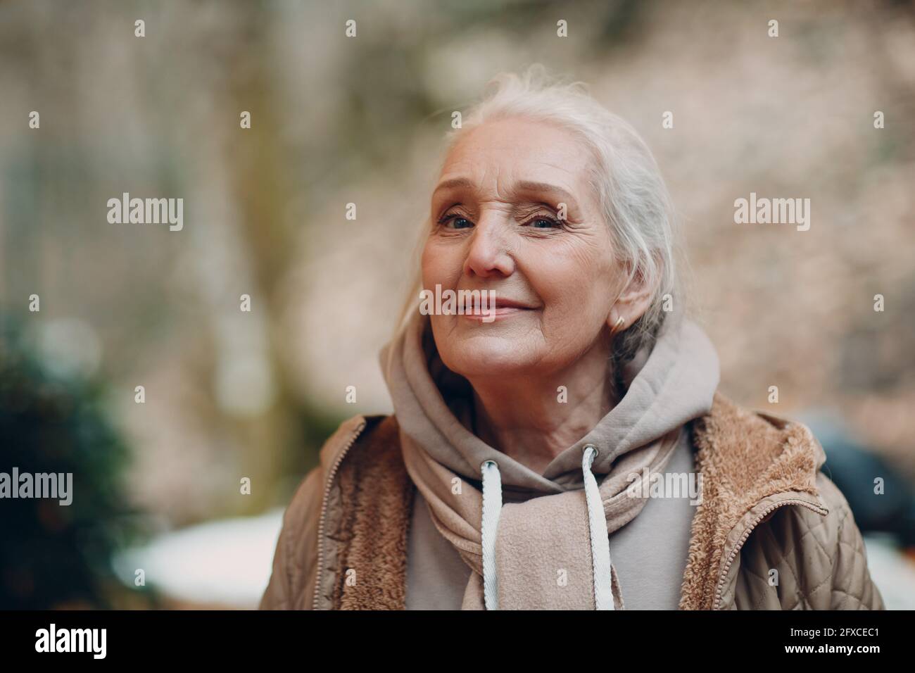 Portrait Of Smiling Gray Haired Elderly Mature Woman Outdoor Stock