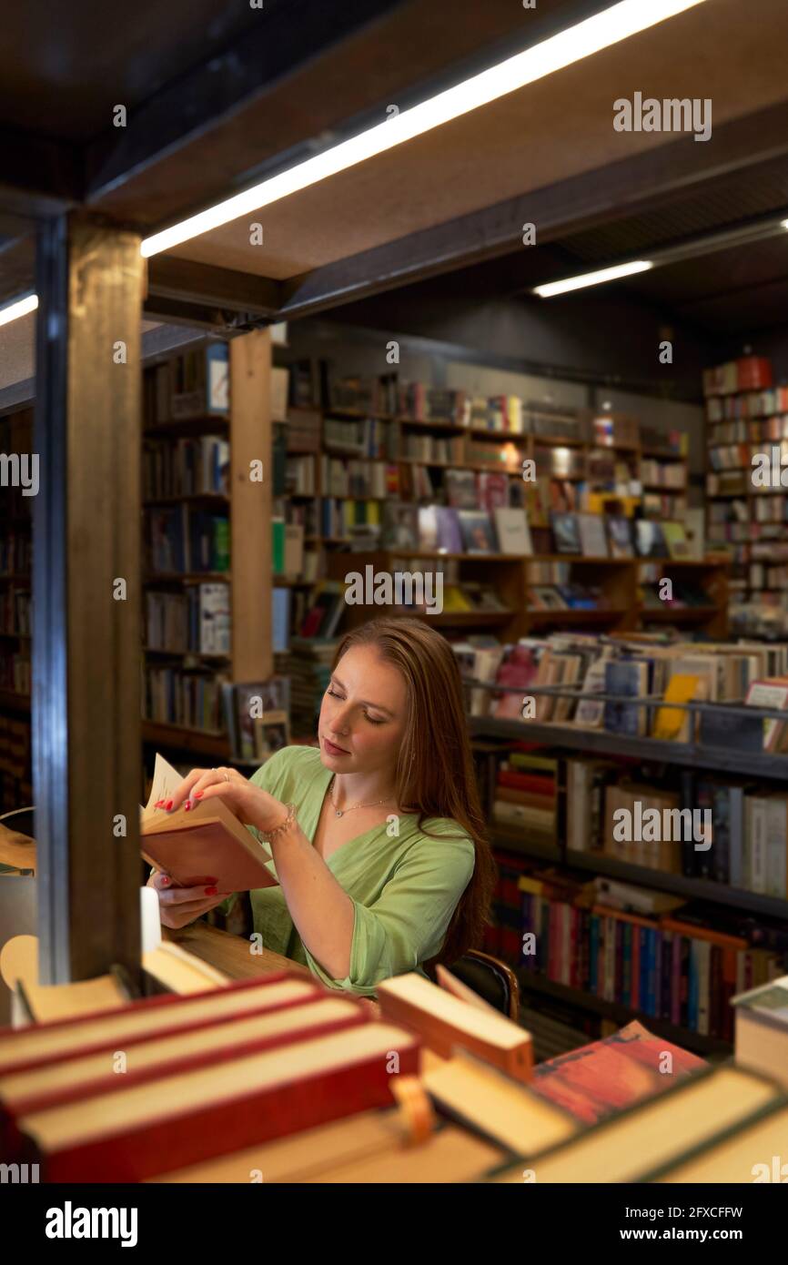 Female student searching book in library Stock Photo - Alamy