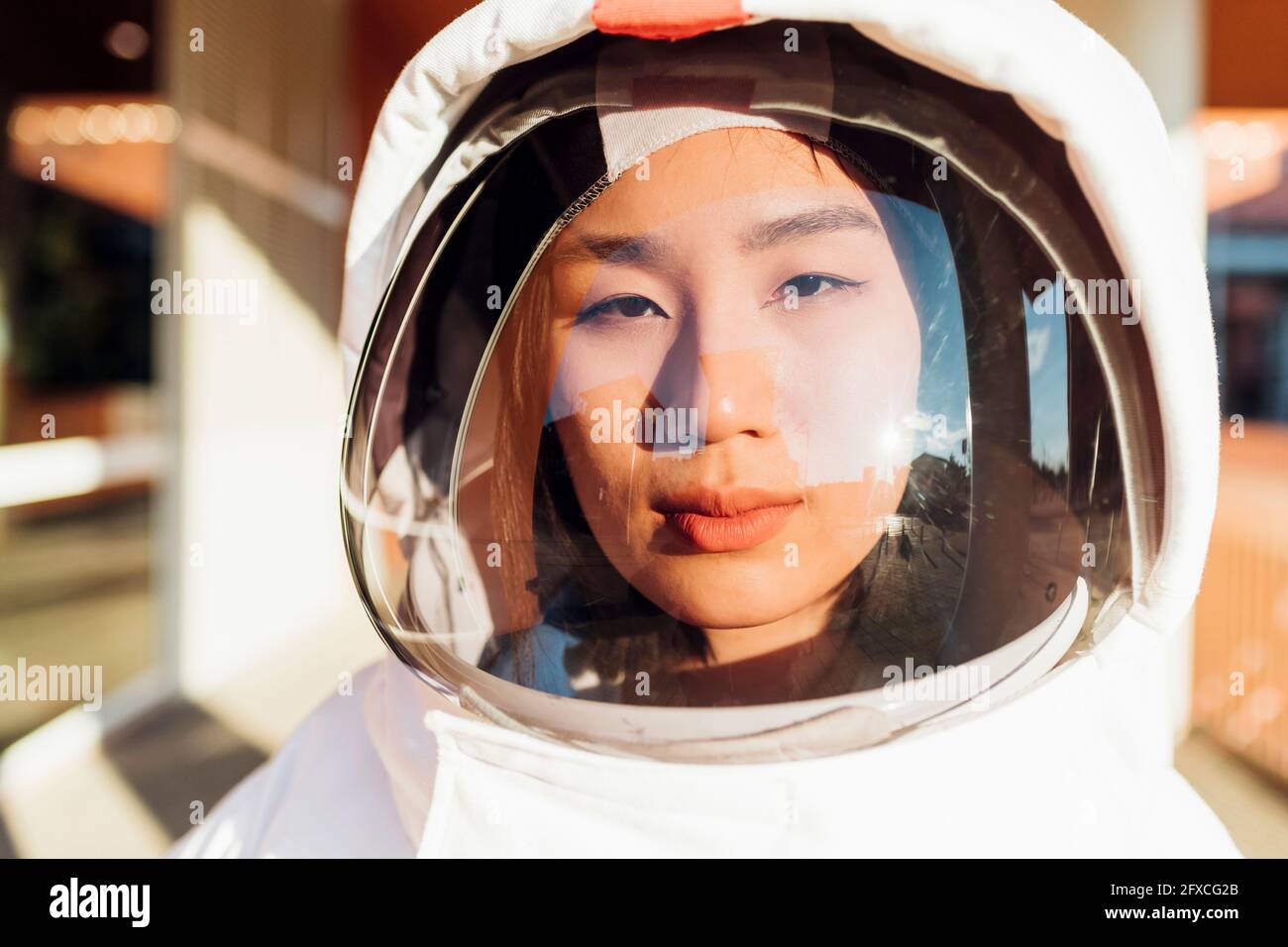 Serious female astronaut in space suit during sunny day Stock Photo - Alamy