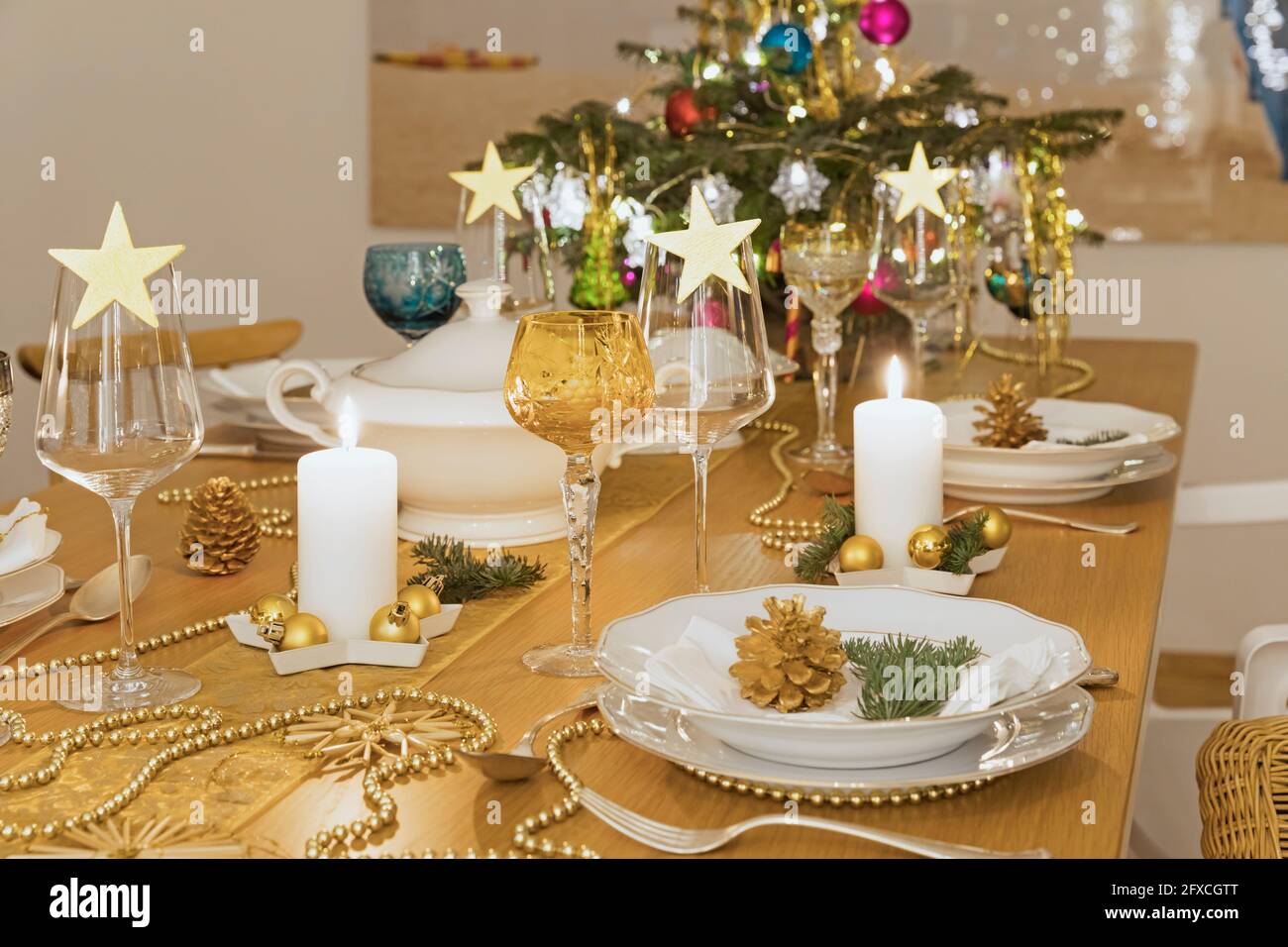 Festive Christmas table with small Christmas tree in background Stock ...