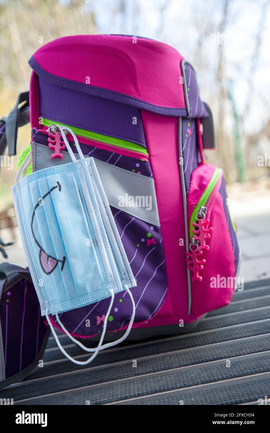 Girl drawing smiley face on protective mask at home Stock Photo - Alamy