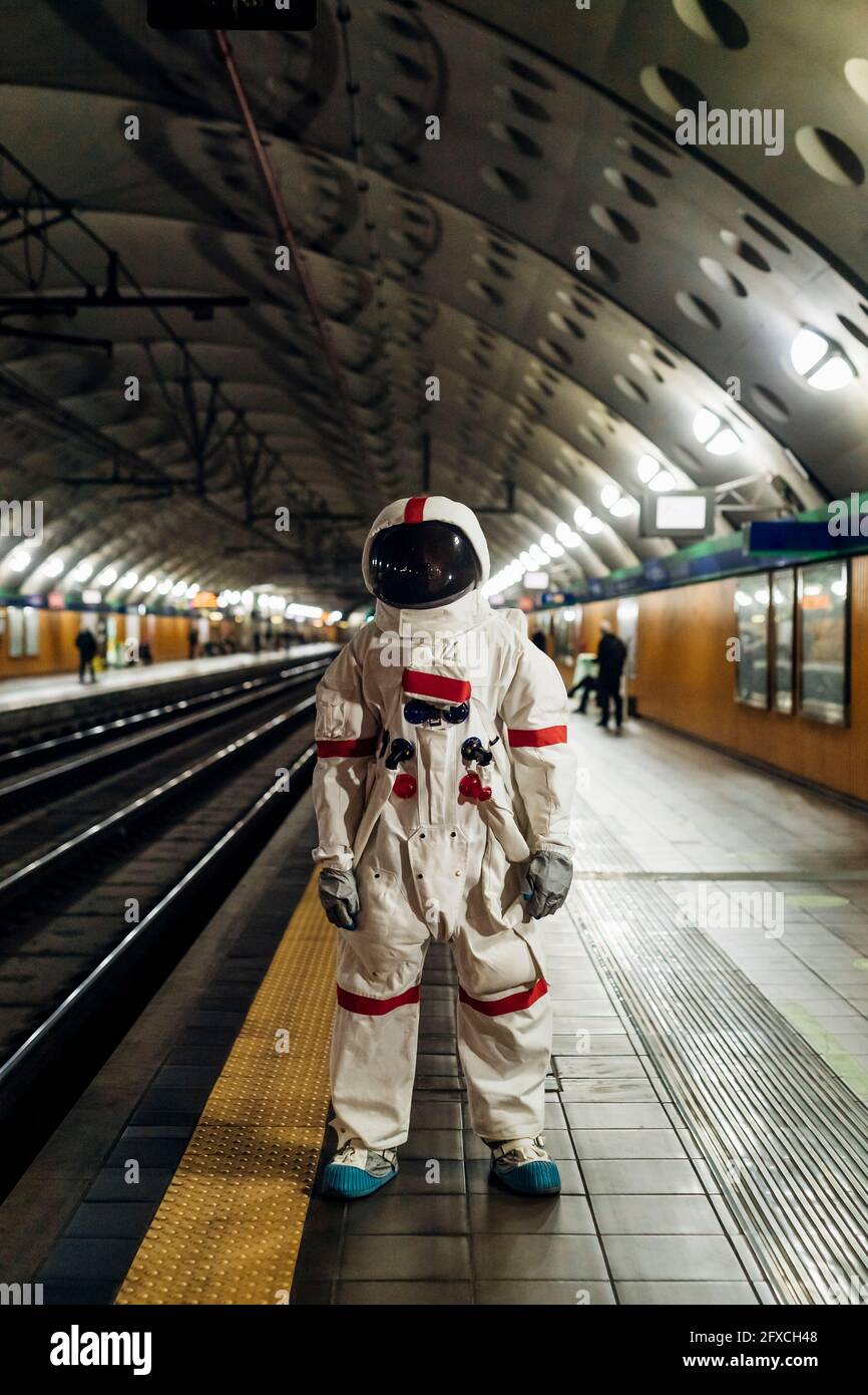 Male astronaut standing on rail road station Stock Photo - Alamy