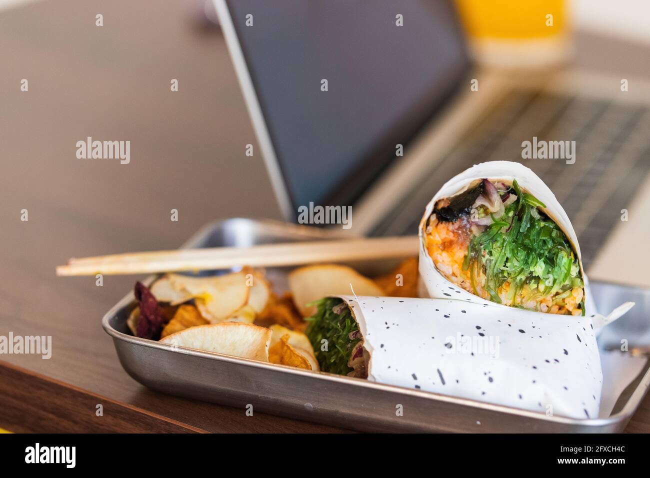 Food and laptop on table in restaurant Stock Photo - Alamy