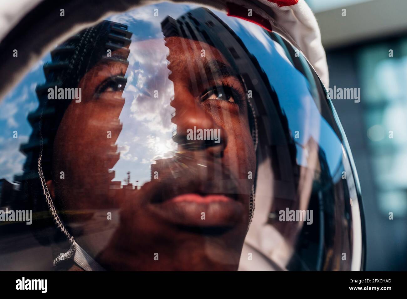 Male astronaut wearing space helmet looking up Stock Photo - Alamy