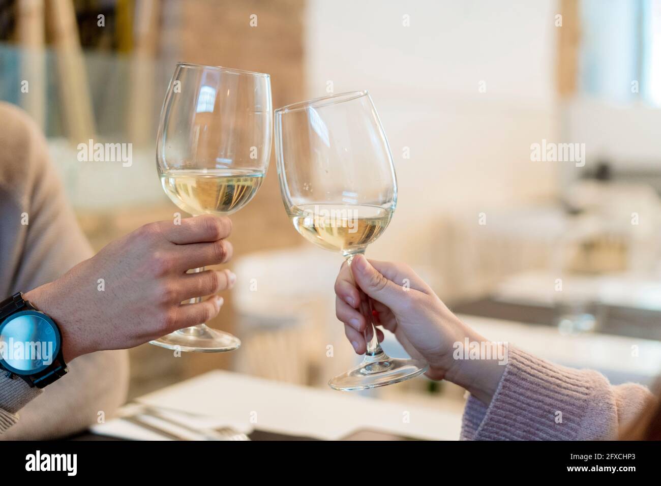 Man and woman raising toast in restaurant Stock Photo - Alamy