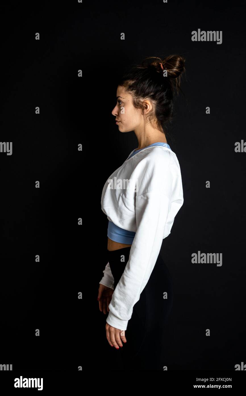 Female sportsperson standing by black background Stock Photo - Alamy