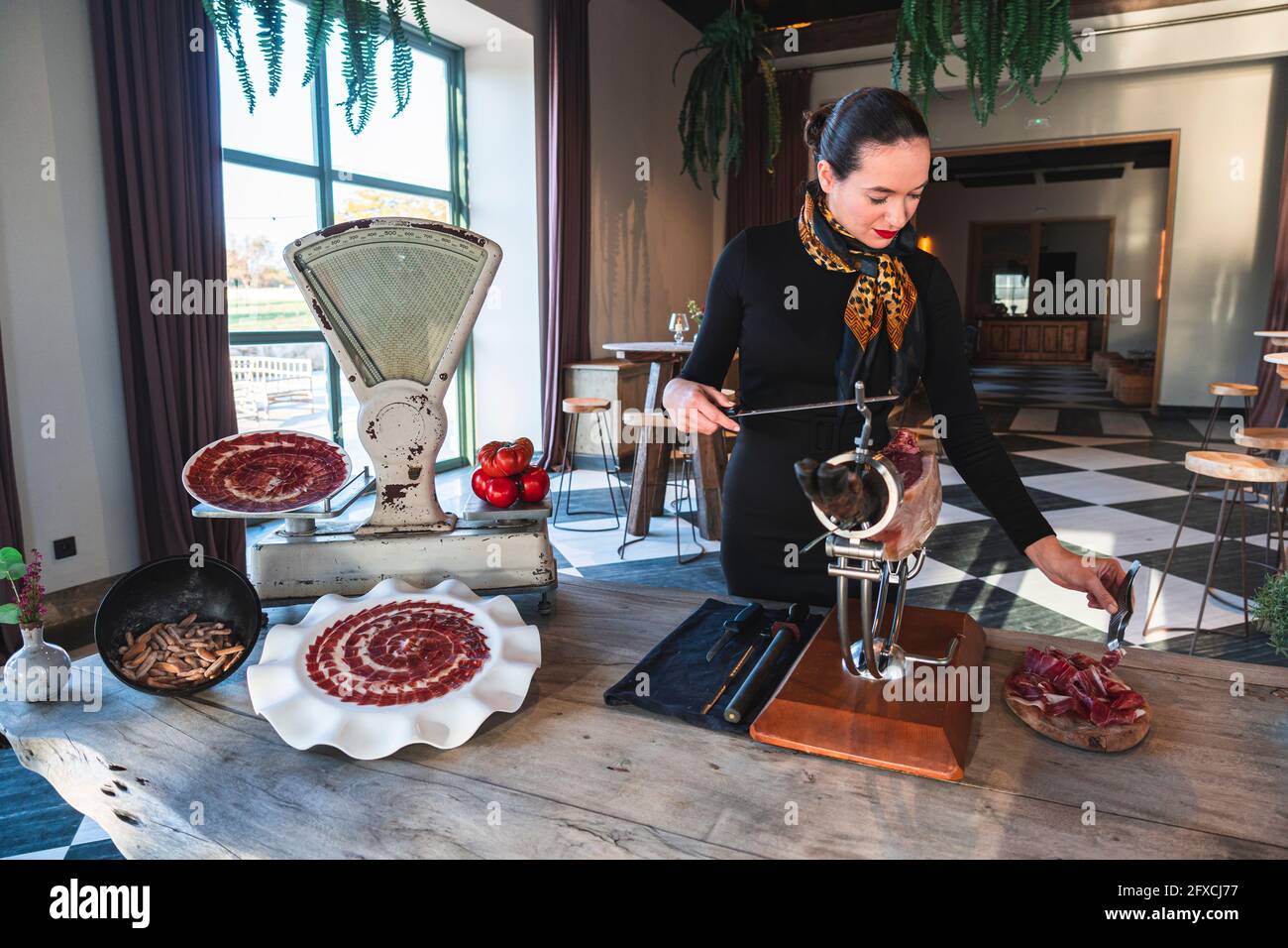 Young female chef arranging slices of ham in restaurant Stock Photo - Alamy