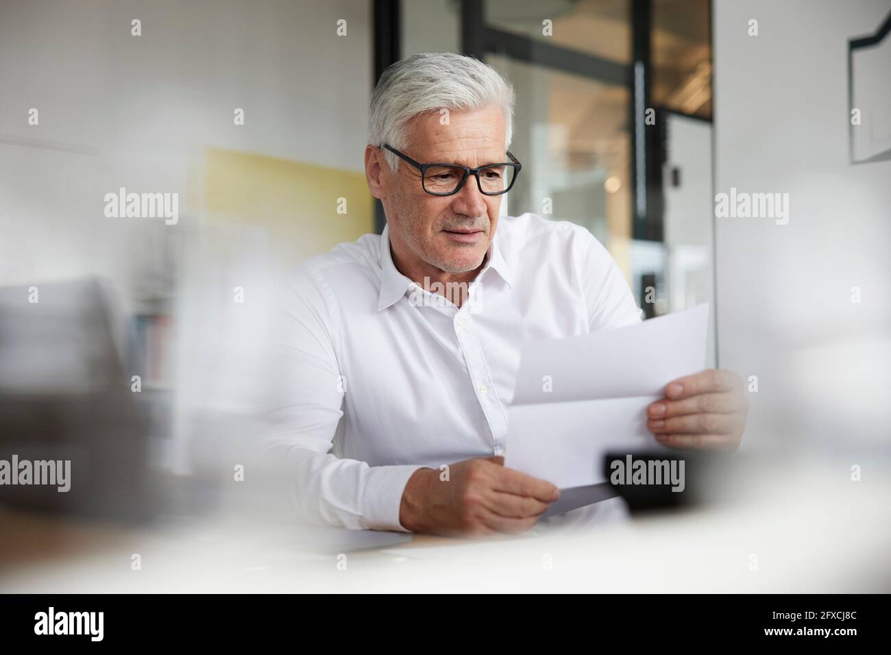 Reading document in office hi-res stock photography and images - Alamy