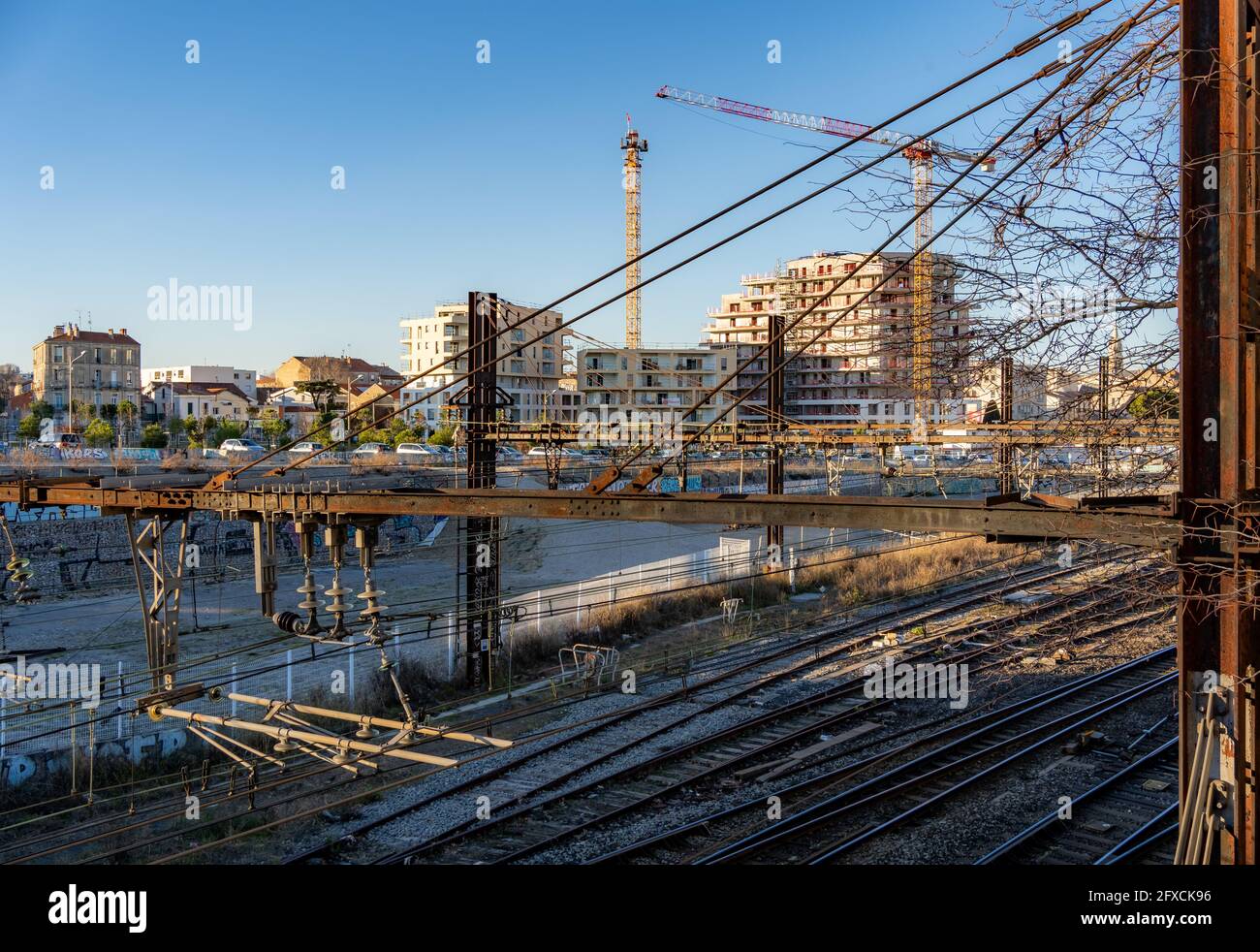 Shot of a construction site of apartment buildings behind railroad ...
