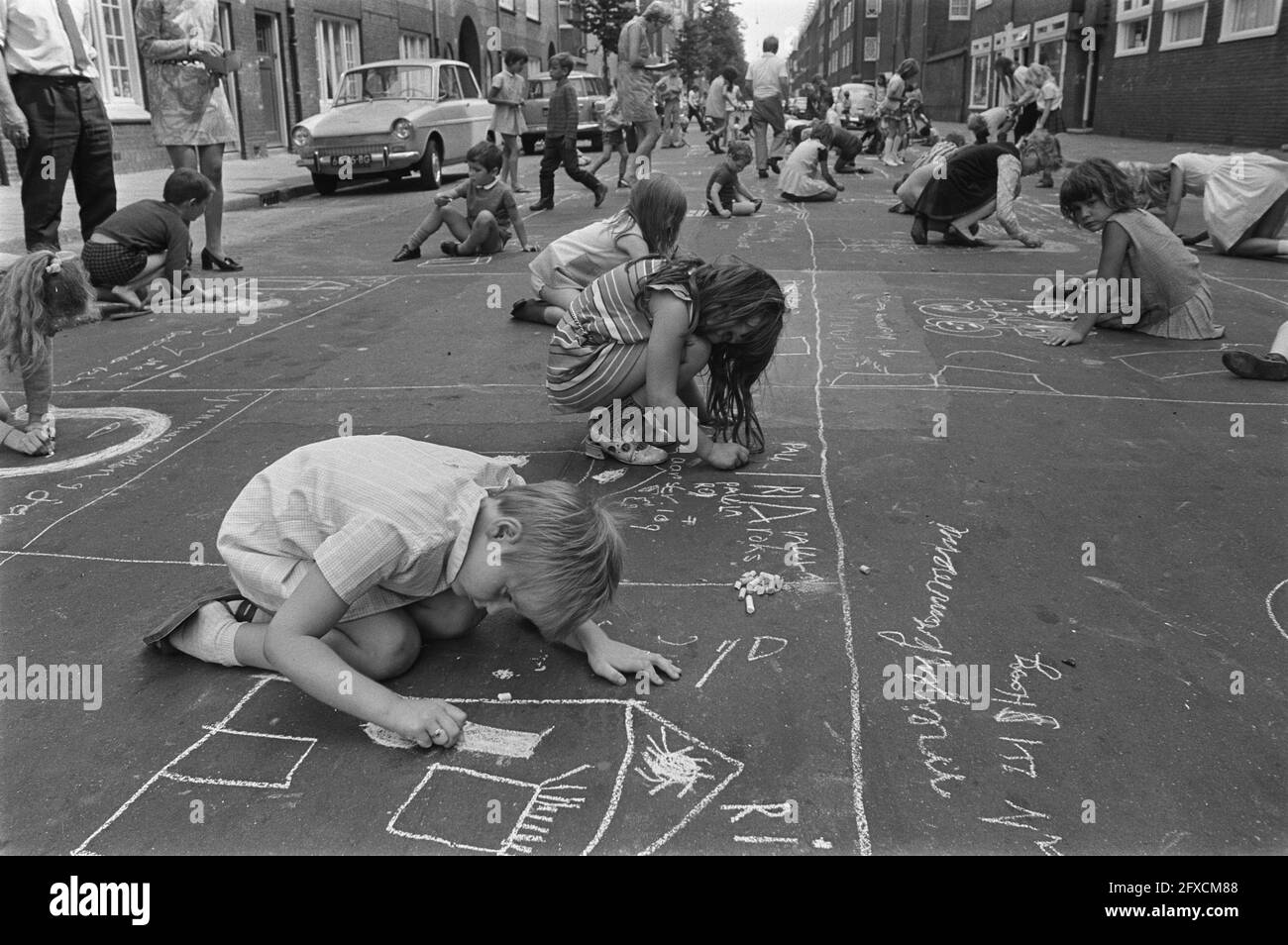 Children are concentrating on their street drawings, July 6, 1970 ...