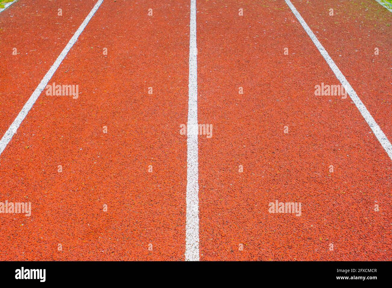 White symmetrical lines of the red running track, leading to the front ...