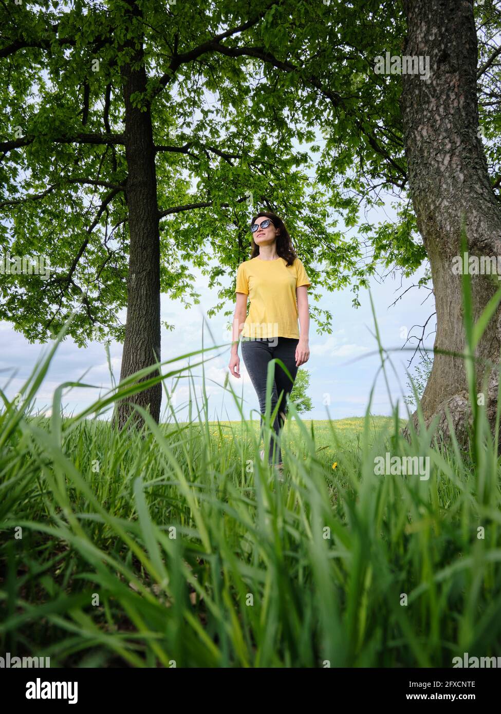 Woman walking alone on a path hi-res stock photography and images - Alamy