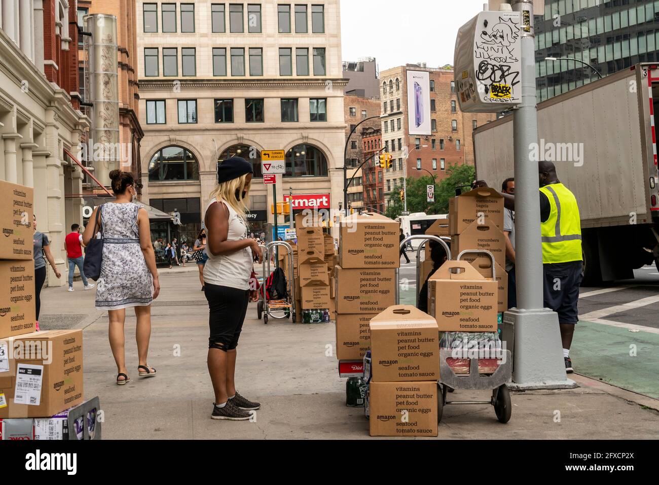 Workers prepare Amazon Fresh deliveries for distribution in the East ...