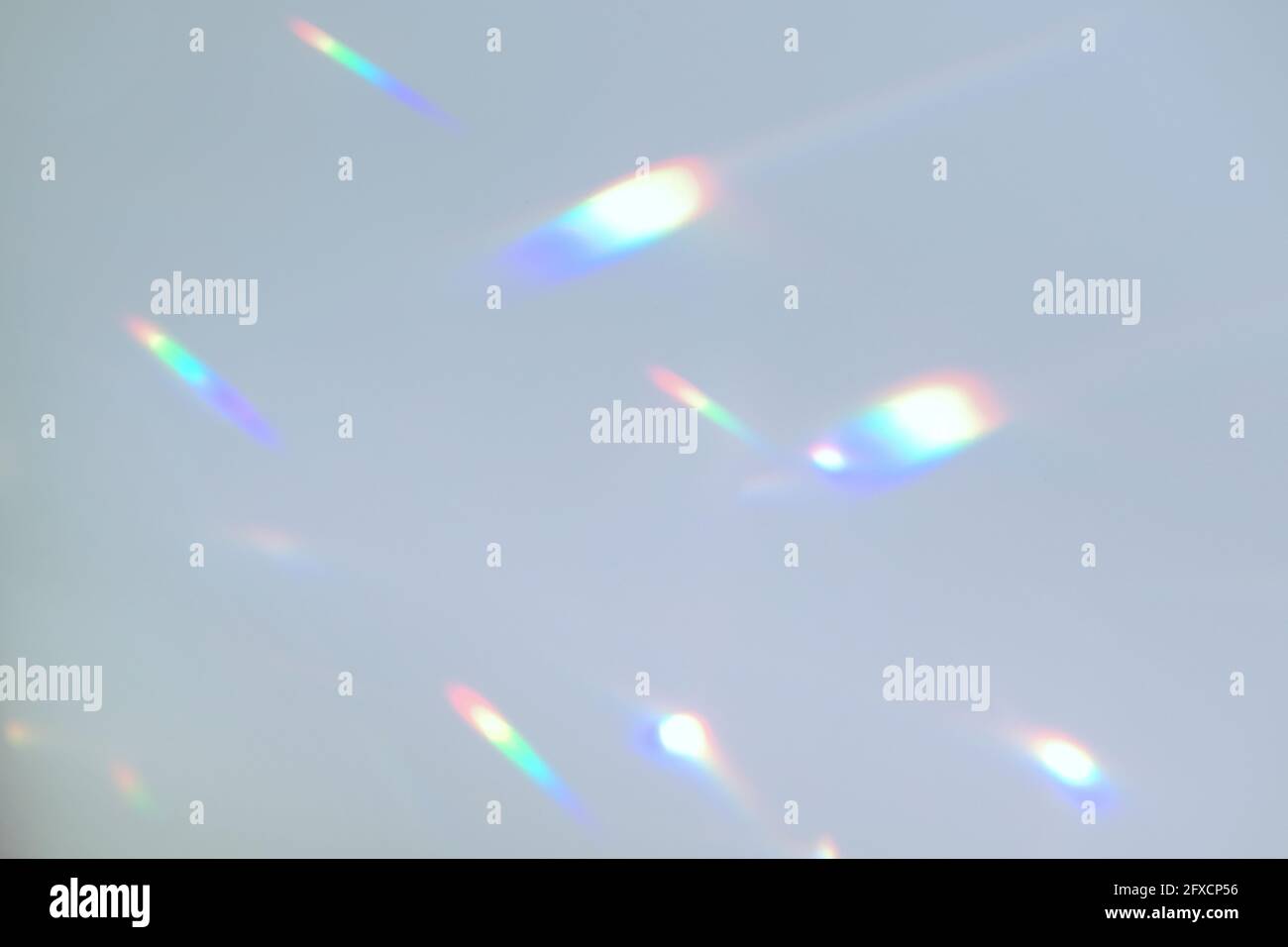 Blurred rainbow light refraction texture on white wall Stock Photo - Alamy