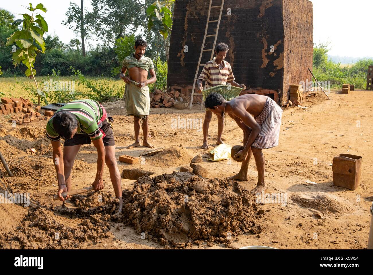 Men making clay bricks by hand in a rural village in Nayagarh, Odisha ...