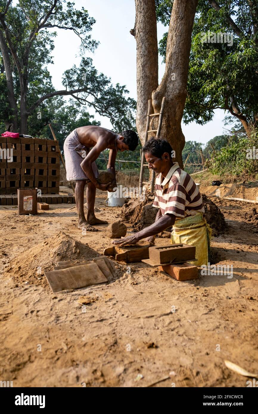 Men making clay bricks by hand in a rural village in Nayagarh, Odisha ...