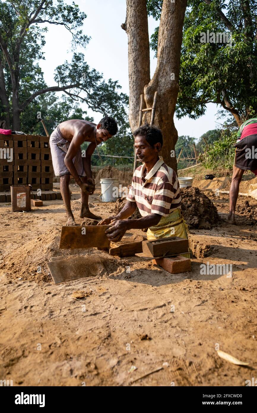 Men making clay bricks by hand in a rural village in Nayagarh, Odisha ...