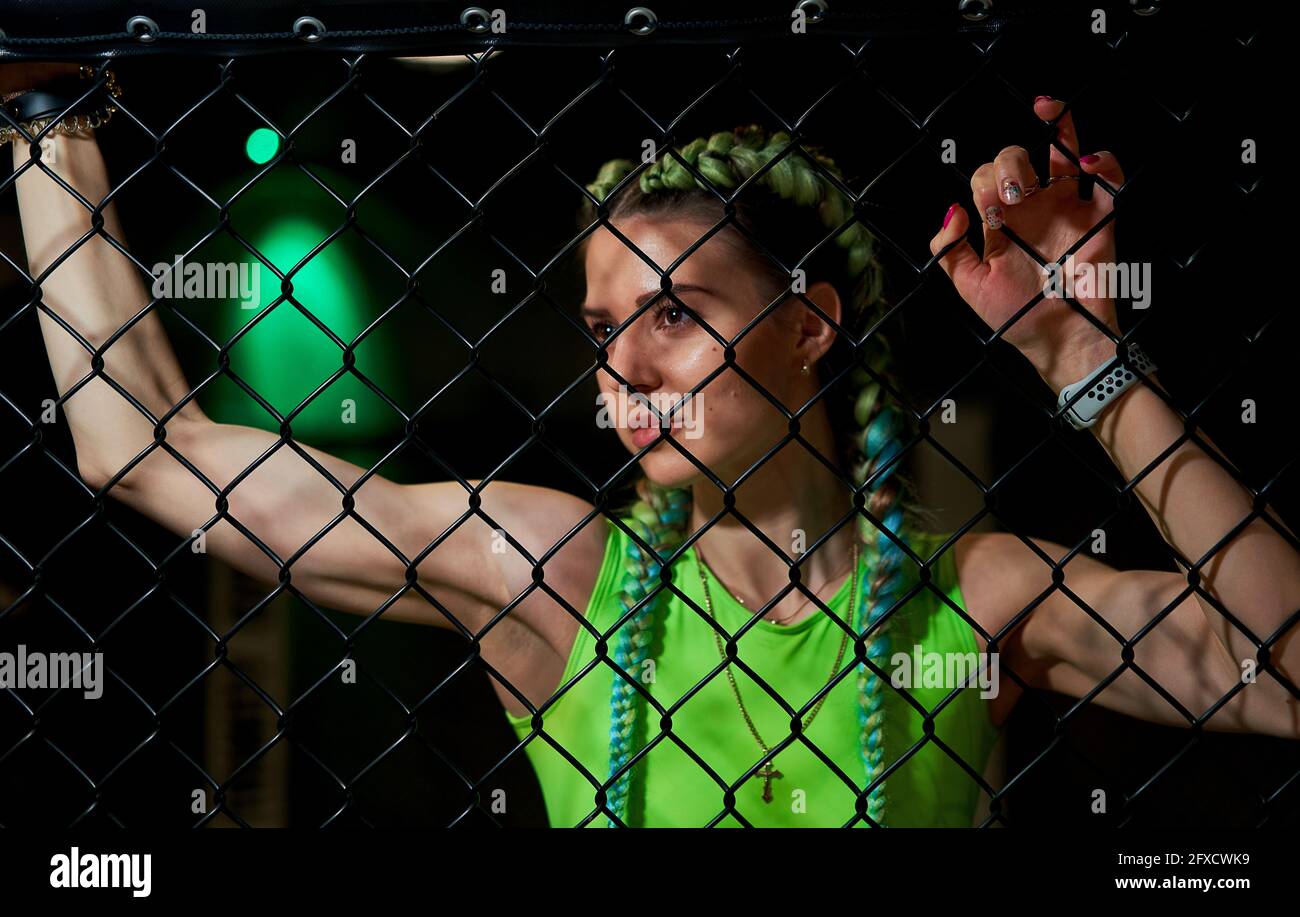 Boxing ring girl poses before a fight in the arena of the octagonal ...