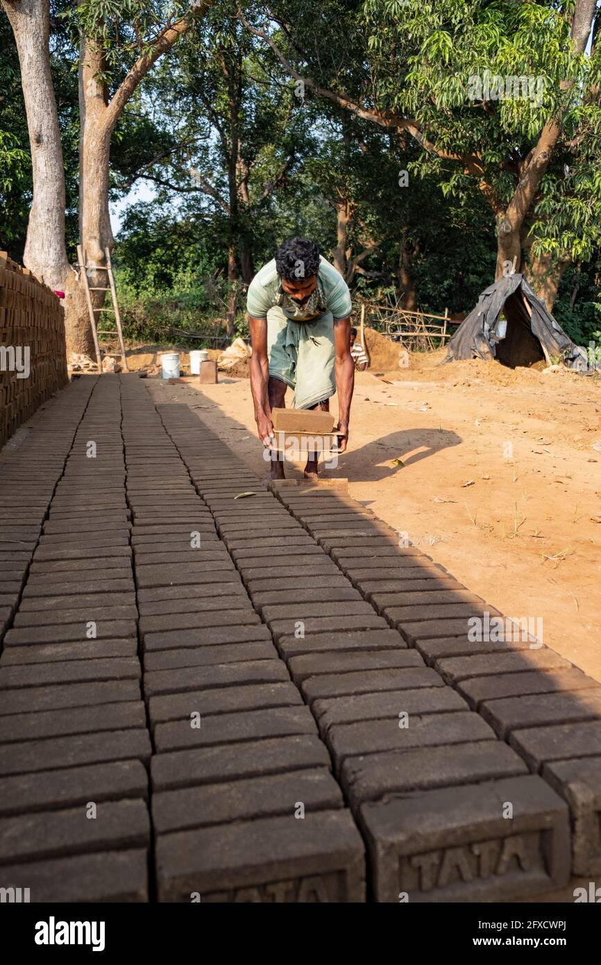 Men making clay bricks by hand in a rural village in Nayagarh, Odisha ...