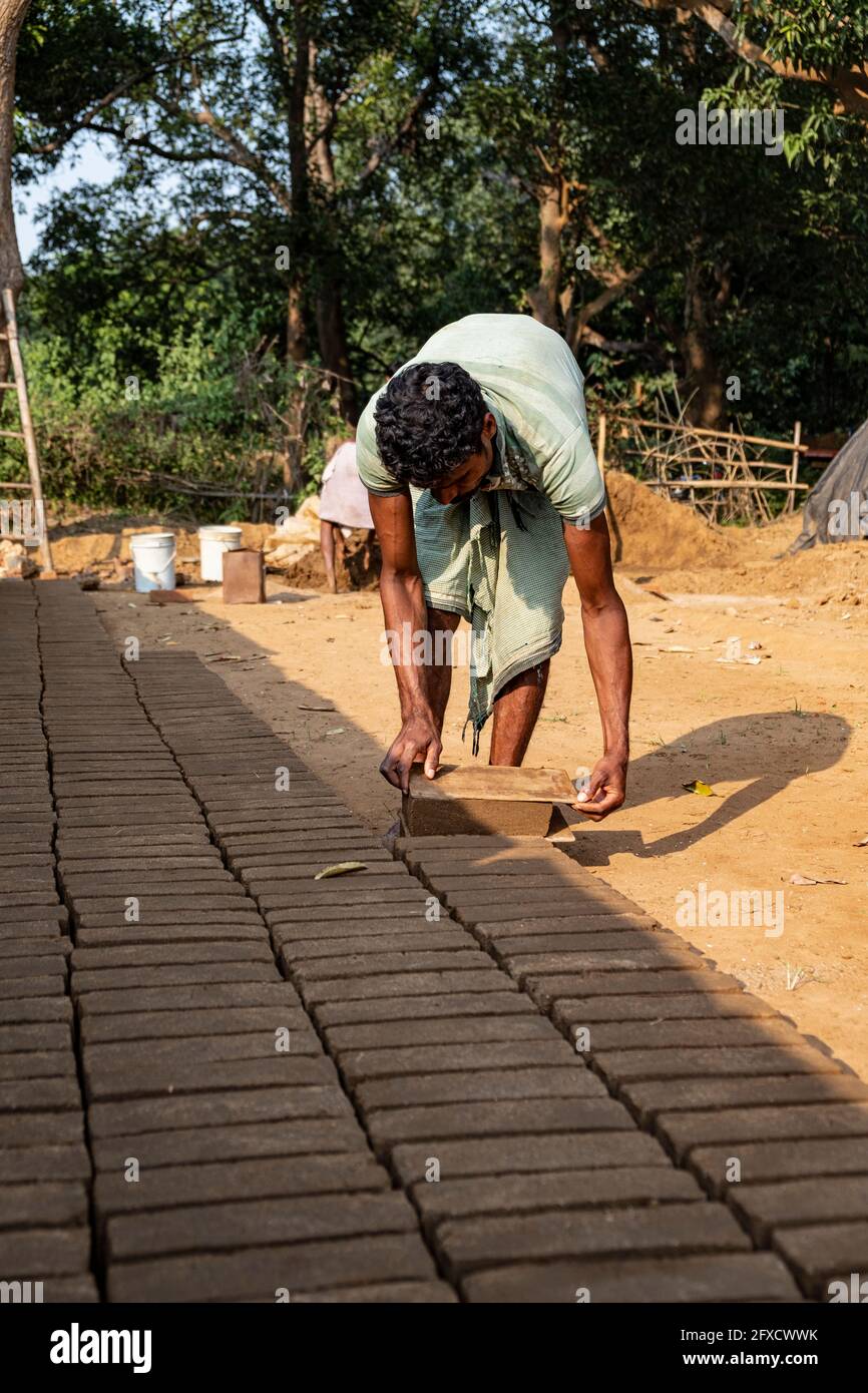 Men making clay bricks by hand in a rural village in Nayagarh, Odisha ...