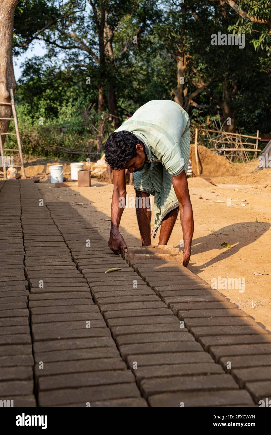 Men making clay bricks by hand in a rural village in Nayagarh, Odisha ...