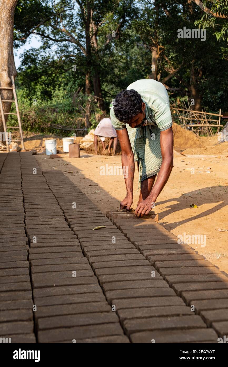 Men making clay bricks by hand in a rural village in Nayagarh, Odisha ...
