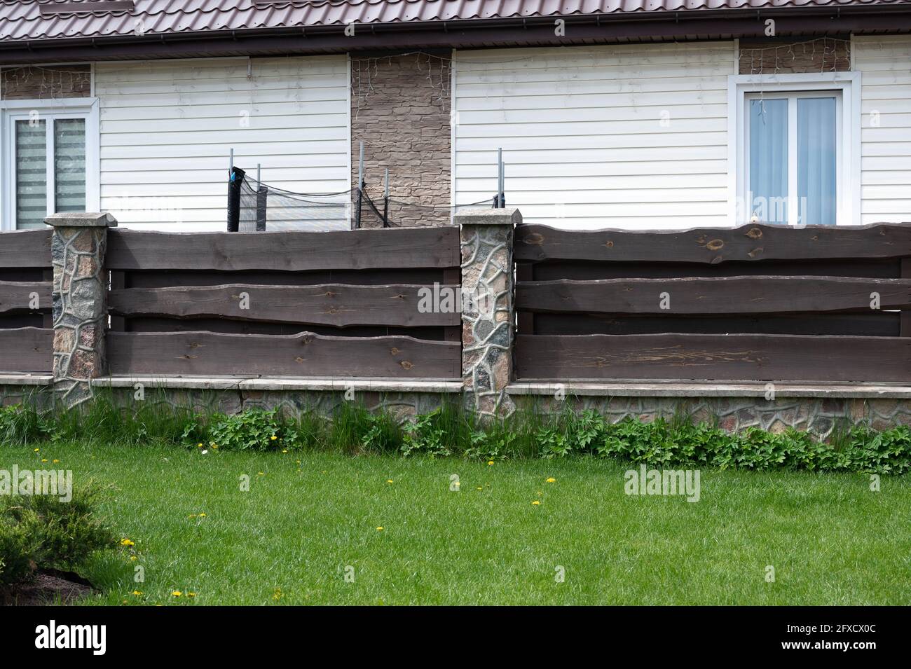 Large solid wood fence. Eco fence Stock Photo - Alamy