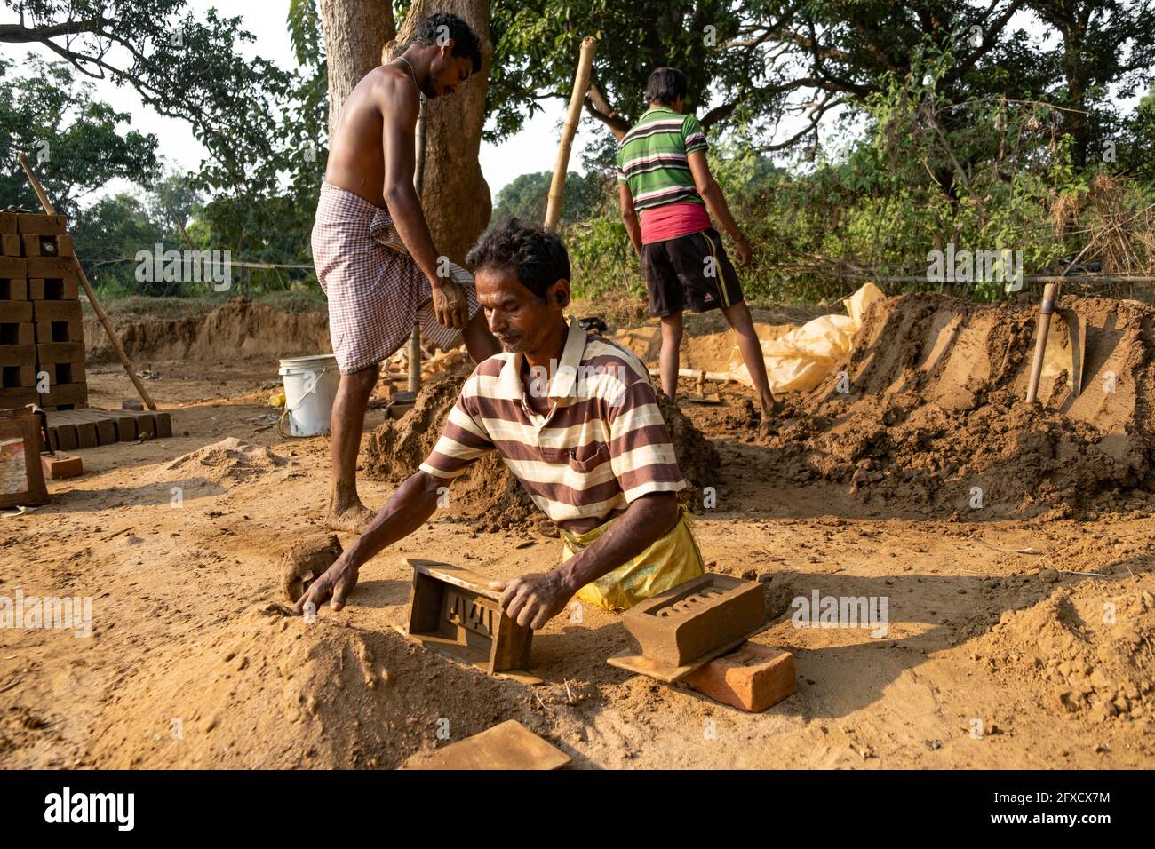 Men making clay bricks by hand in a rural village in Nayagarh, Odisha ...