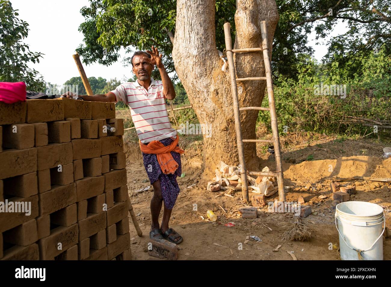Men making clay bricks by hand in a rural village in Nayagarh, Odisha ...