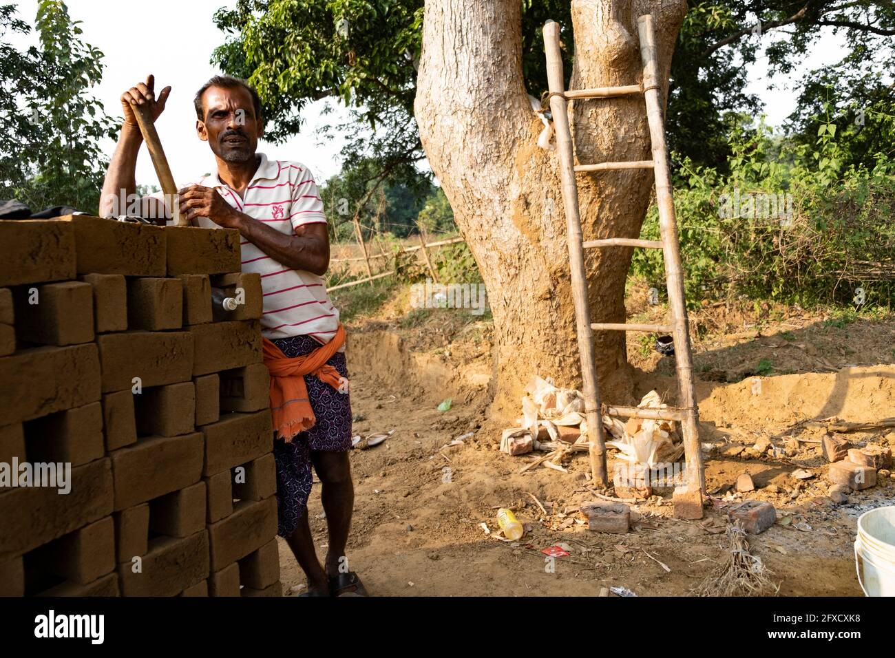 Men making clay bricks by hand in a rural village in Nayagarh, Odisha ...
