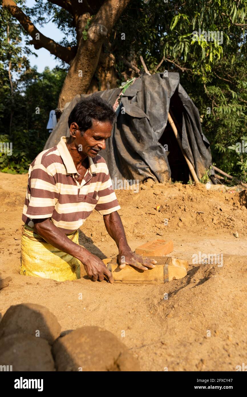 Men making clay bricks by hand in a rural village in Nayagarh, Odisha ...