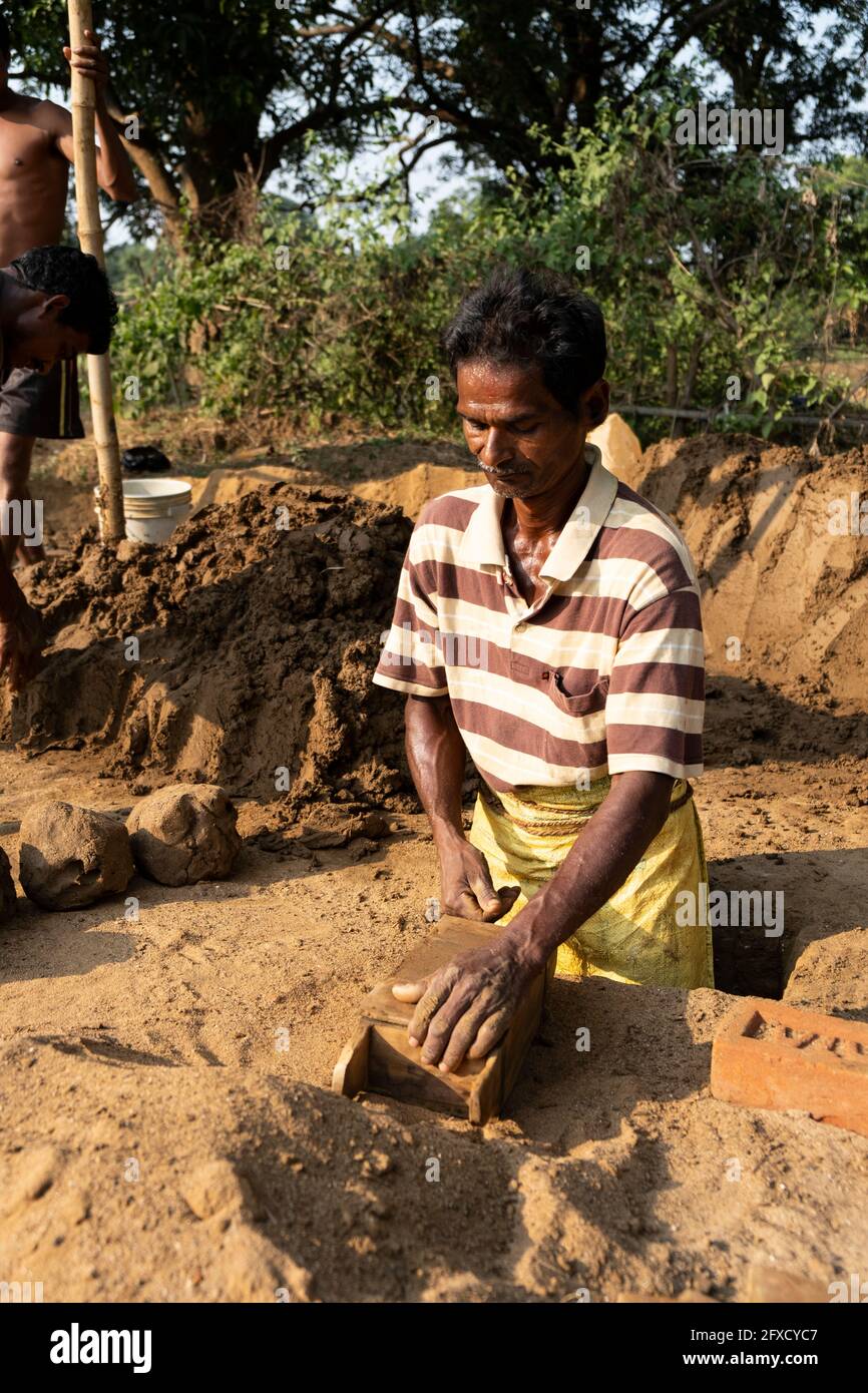 Men making clay bricks by hand in a rural village in Nayagarh, Odisha ...