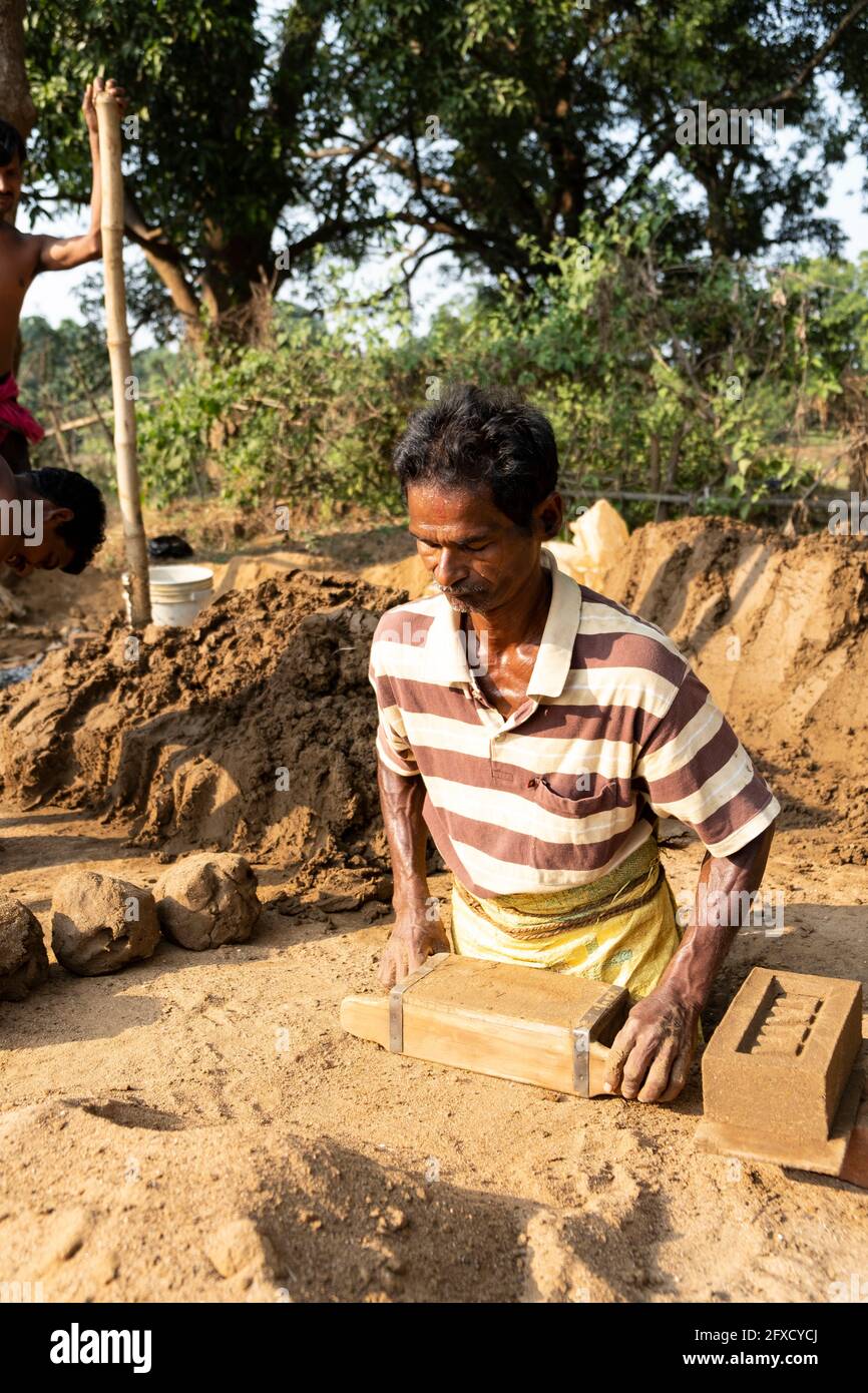 Men making clay bricks by hand in a rural village in Nayagarh, Odisha ...