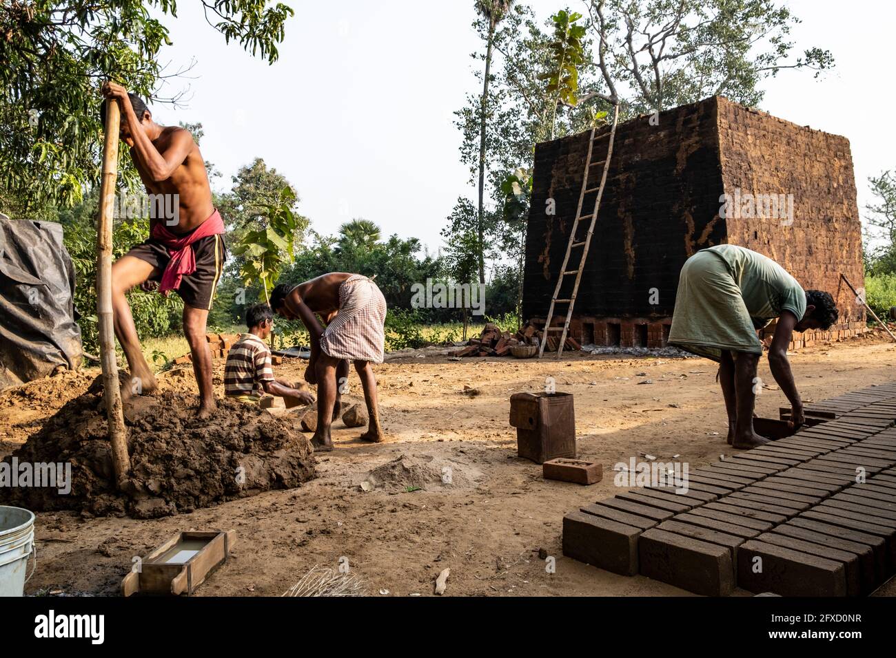 Men making clay bricks by hand in a rural village in Nayagarh, Odisha ...