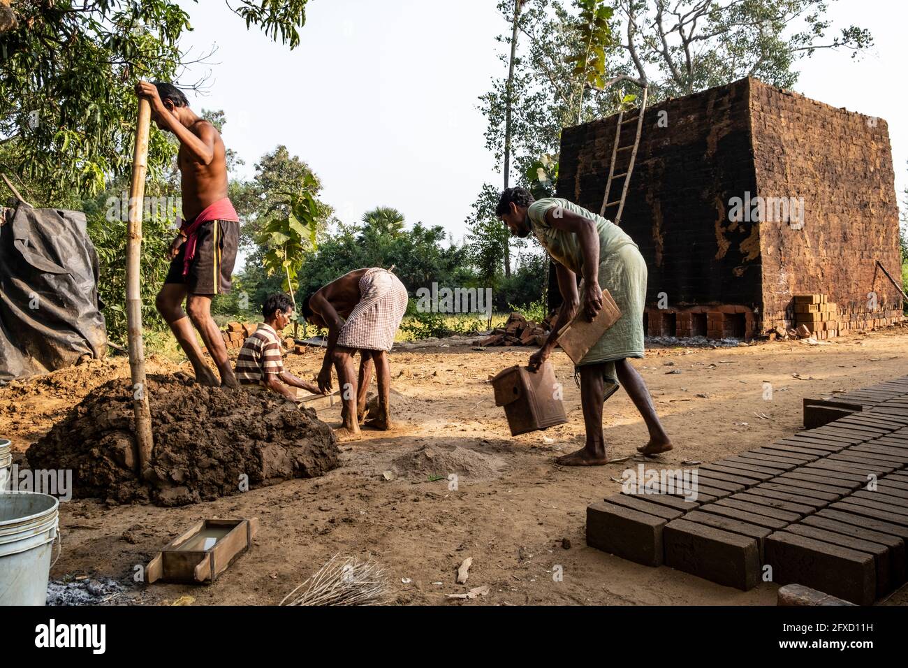 Men making clay bricks by hand in a rural village in Nayagarh, Odisha ...