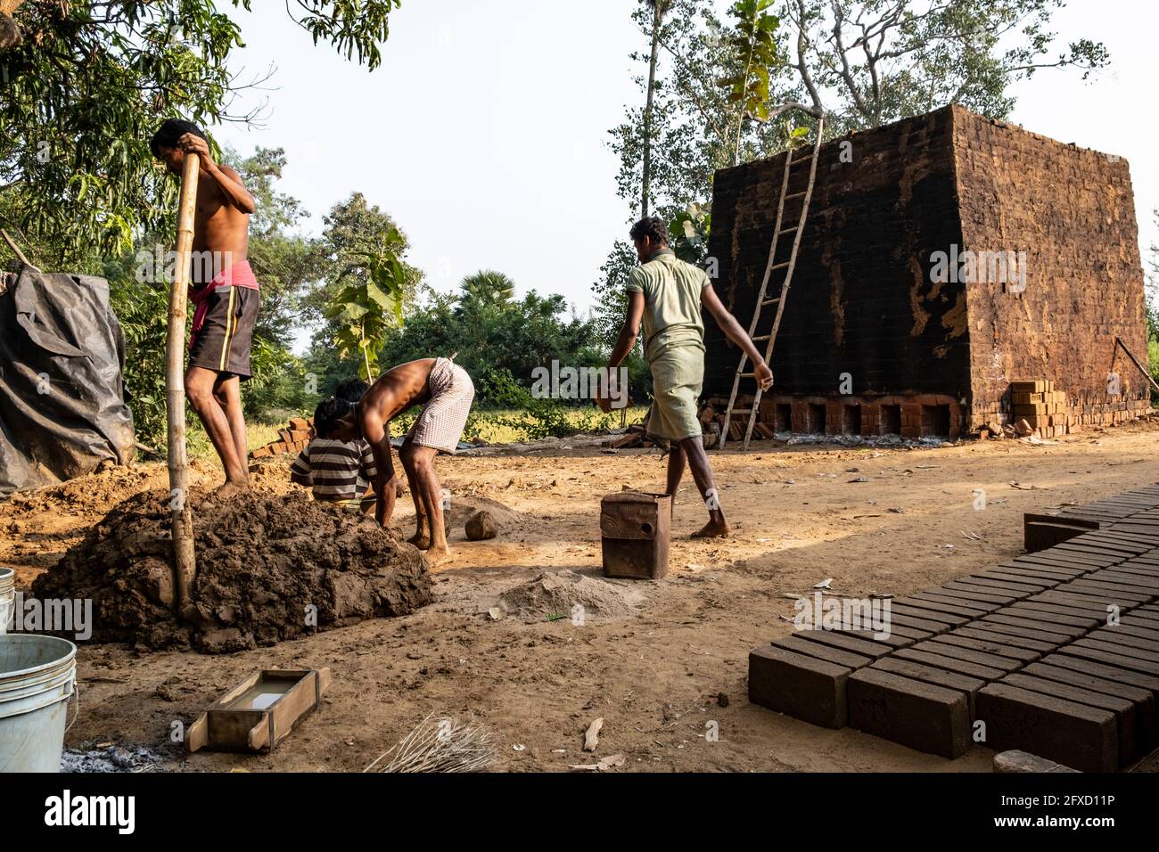 Men making clay bricks by hand in a rural village in Nayagarh, Odisha ...