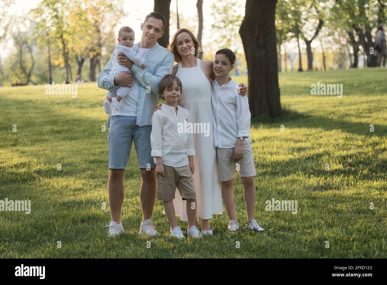Happy harmonious family with three kids outdoors. Family portrait in ...