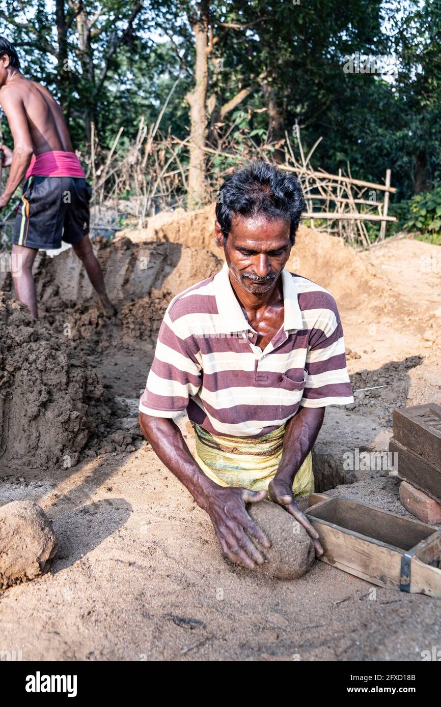 Men making clay bricks by hand in a rural village in Nayagarh, Odisha ...