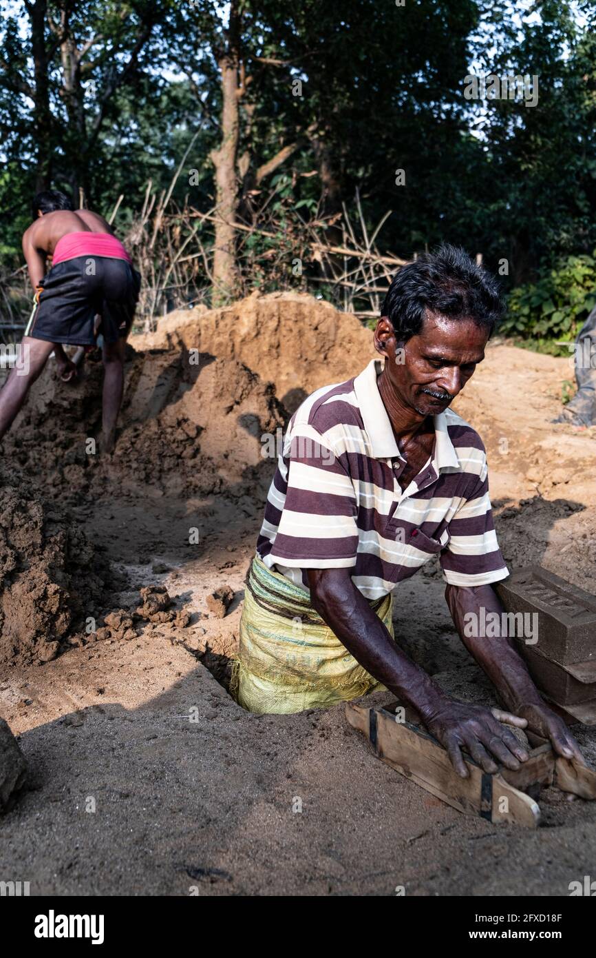 Men making clay bricks by hand in a rural village in Nayagarh, Odisha ...