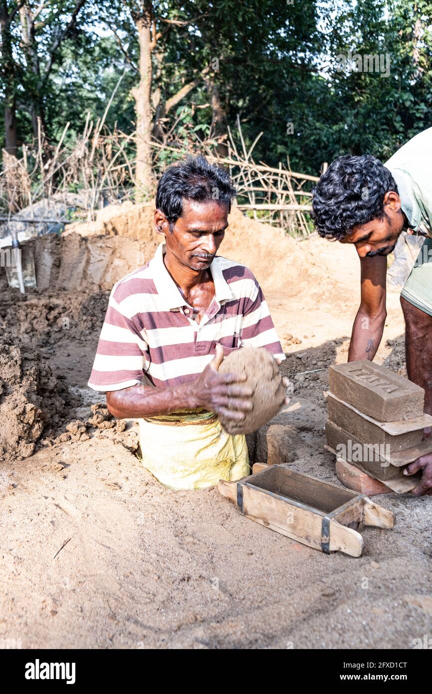 Men making clay bricks by hand in a rural village in Nayagarh, Odisha ...
