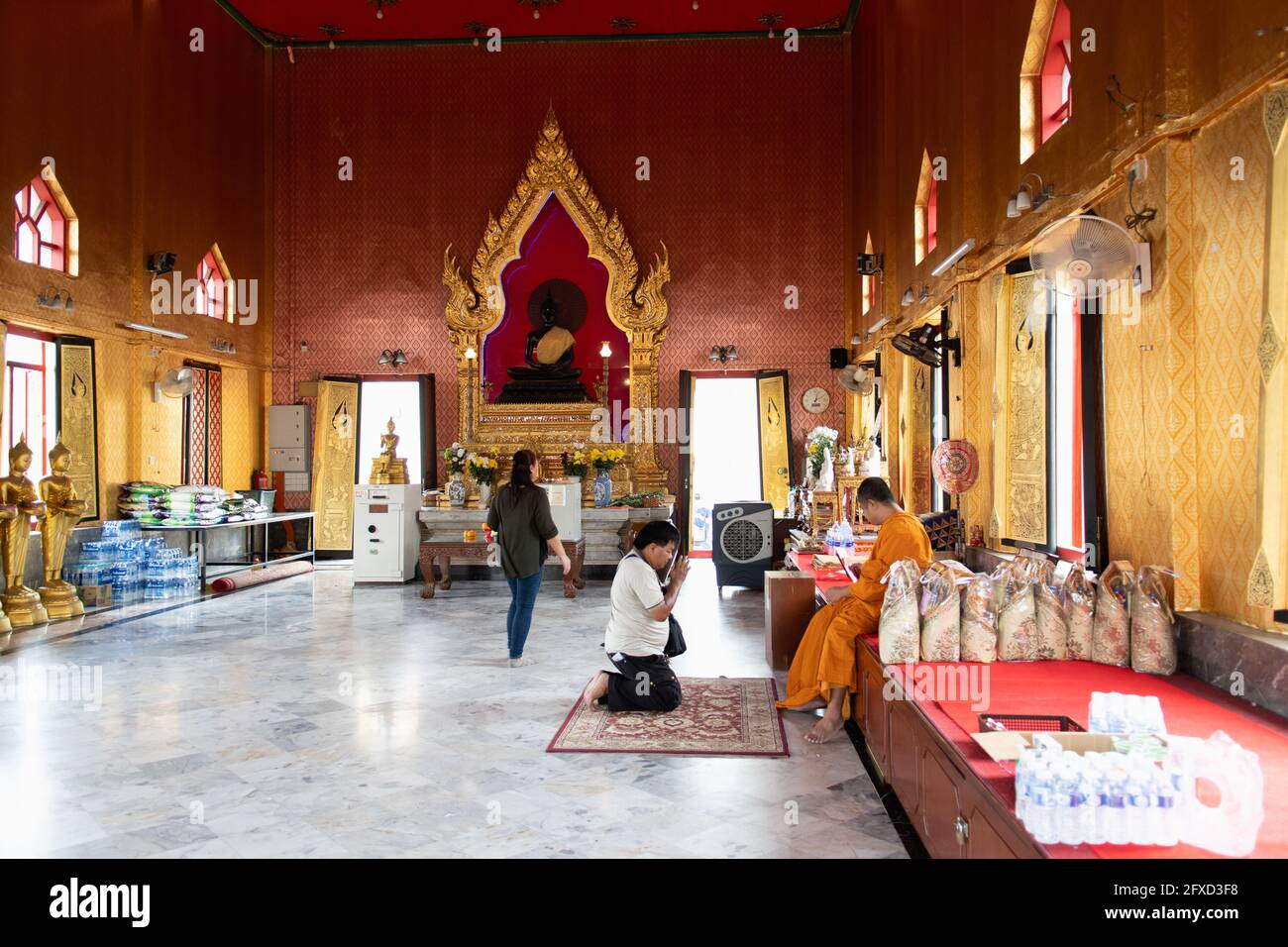 Interior of Thai Buddhist Chetawan Temple. Monk giving blessings to ...