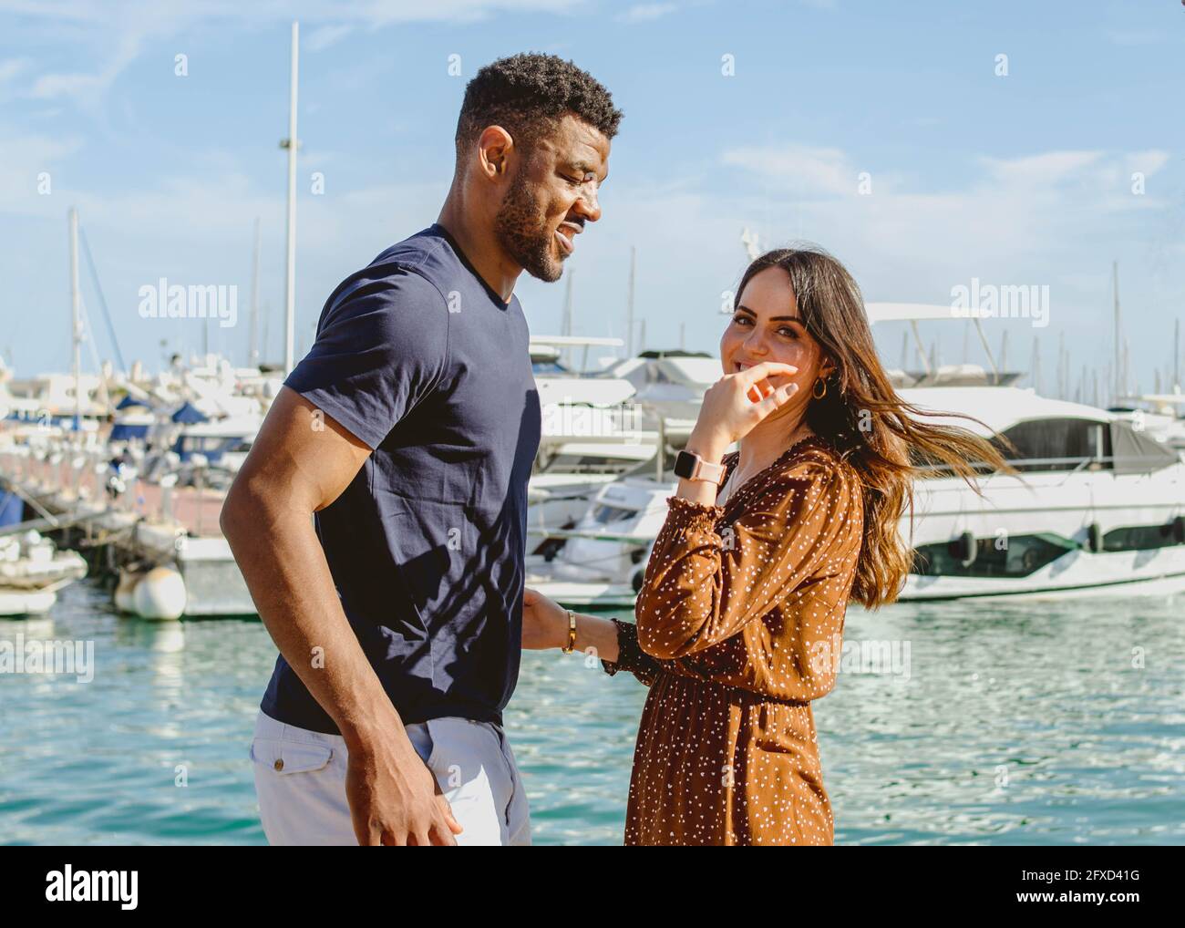 Multiethnic Young Couple Cuddling at Harbor With Boats Background ...