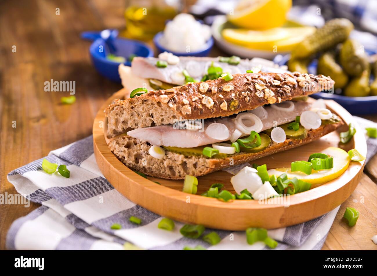 Dutch herring in a sandwich in grain bread with fresh green onions ...