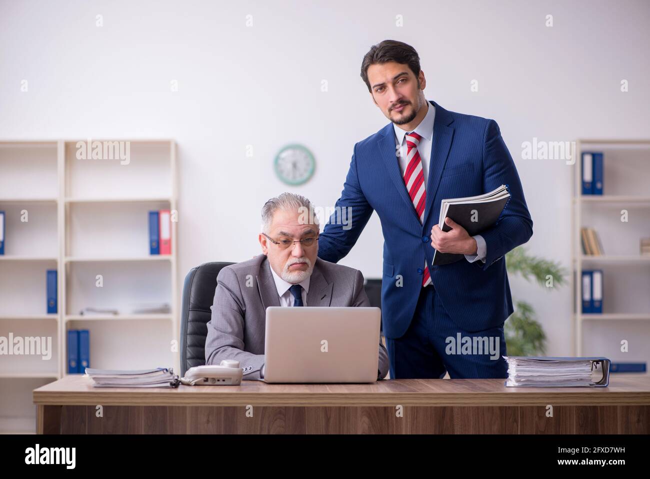 Two employees working in the office Stock Photo - Alamy