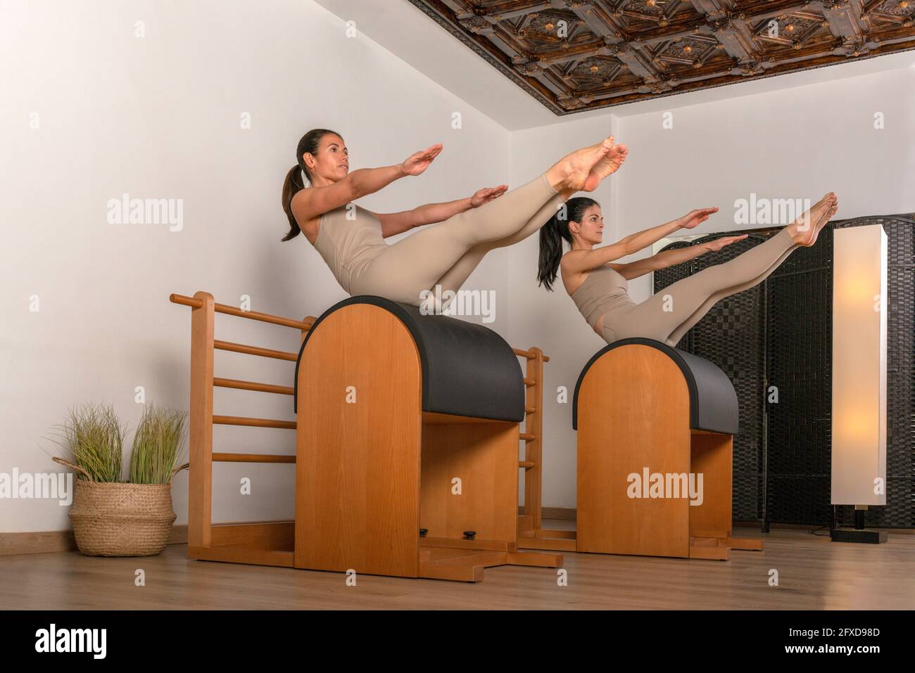 two girls doing pilates exercise teaser Stock Photo - Alamy